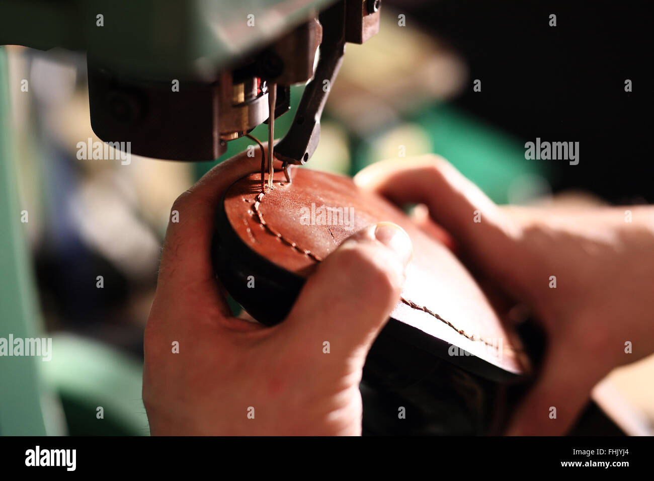 Shoemaker sews shoes. Shoe uppers sewing machine to a professional ...