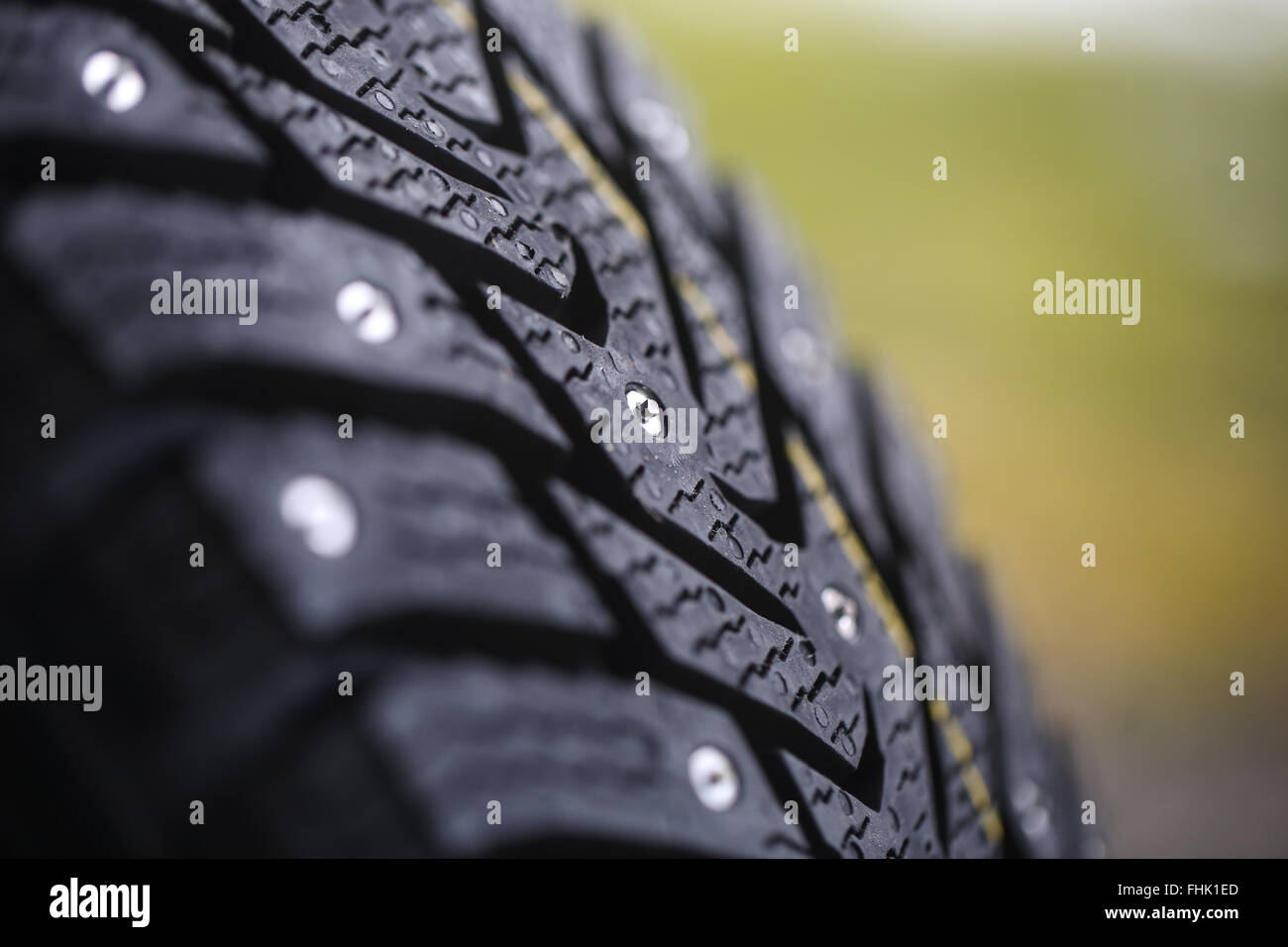 Studded tire on a gray background Stock Photo - Alamy