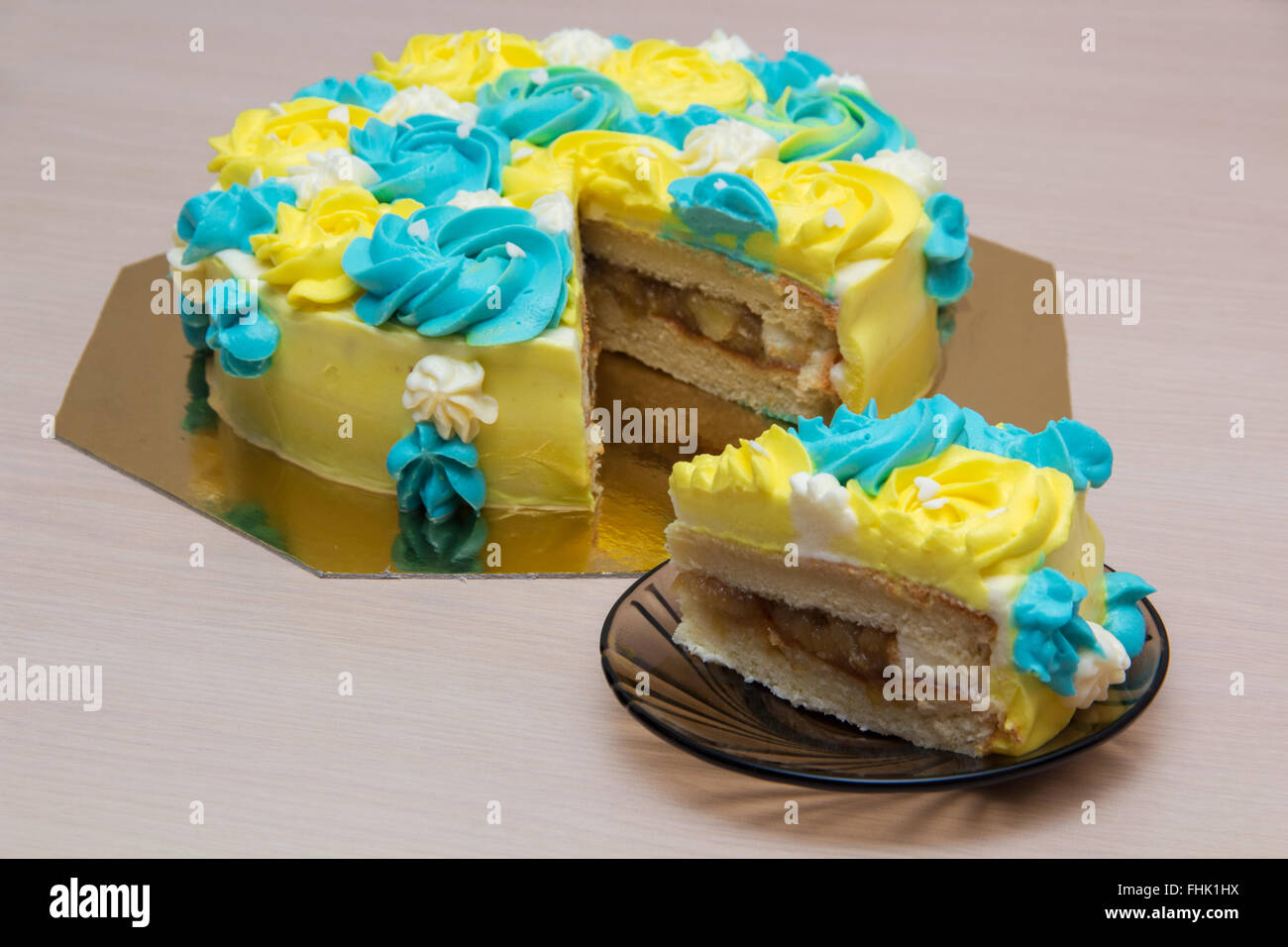 sliced sponge cake with a blue and yellow cream Stock Photo - Alamy