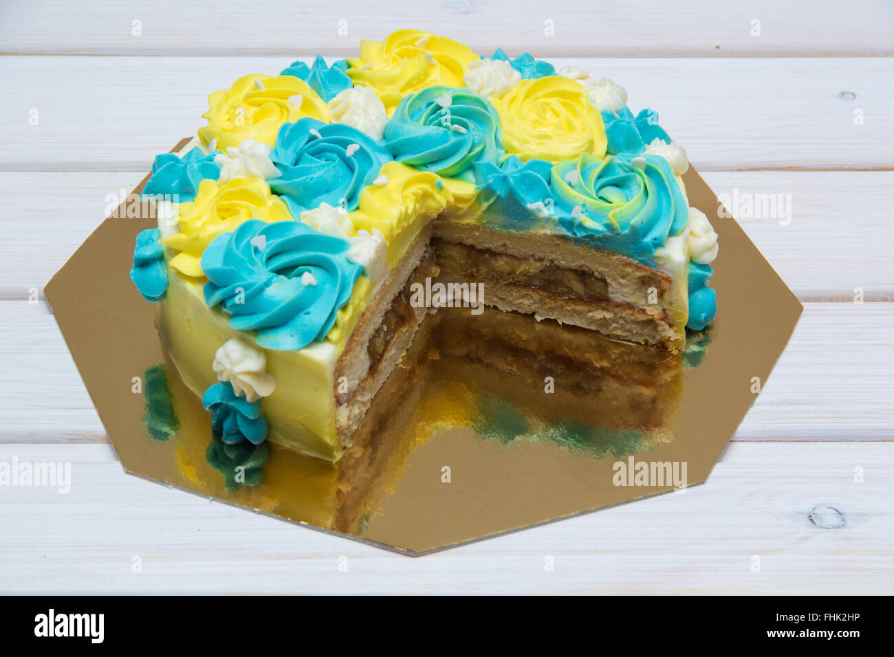 sliced sponge cake with a blue and yellow cream Stock Photo - Alamy