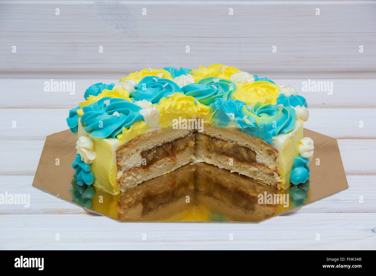 sliced sponge cake with a blue and yellow cream Stock Photo - Alamy