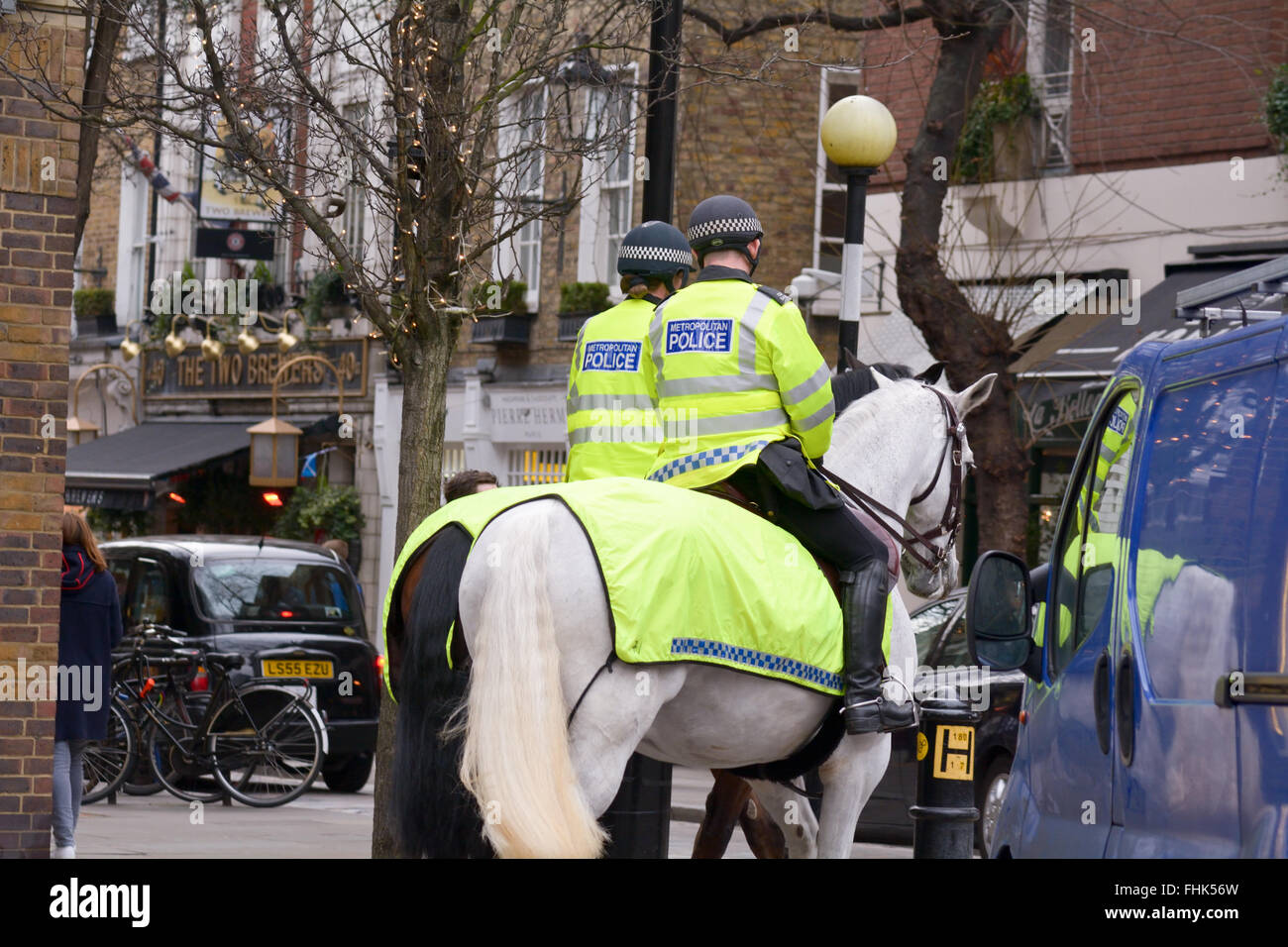 Two Metropolitan Police Officers patrolling the streets on horseback in ...