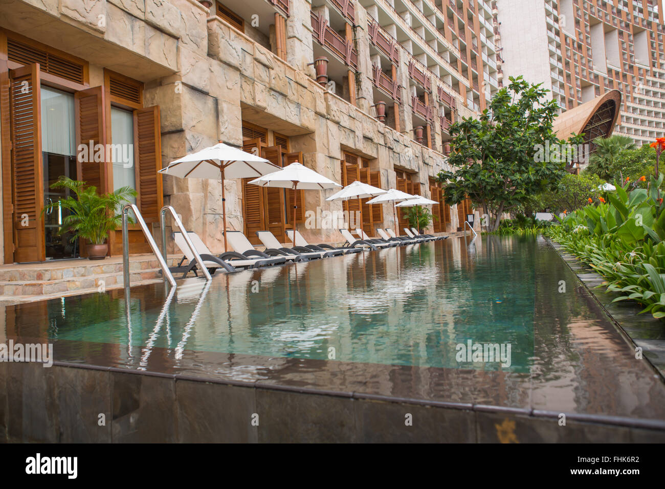 Swimming pool with stair and stone deck at hotel Stock Photo - Alamy