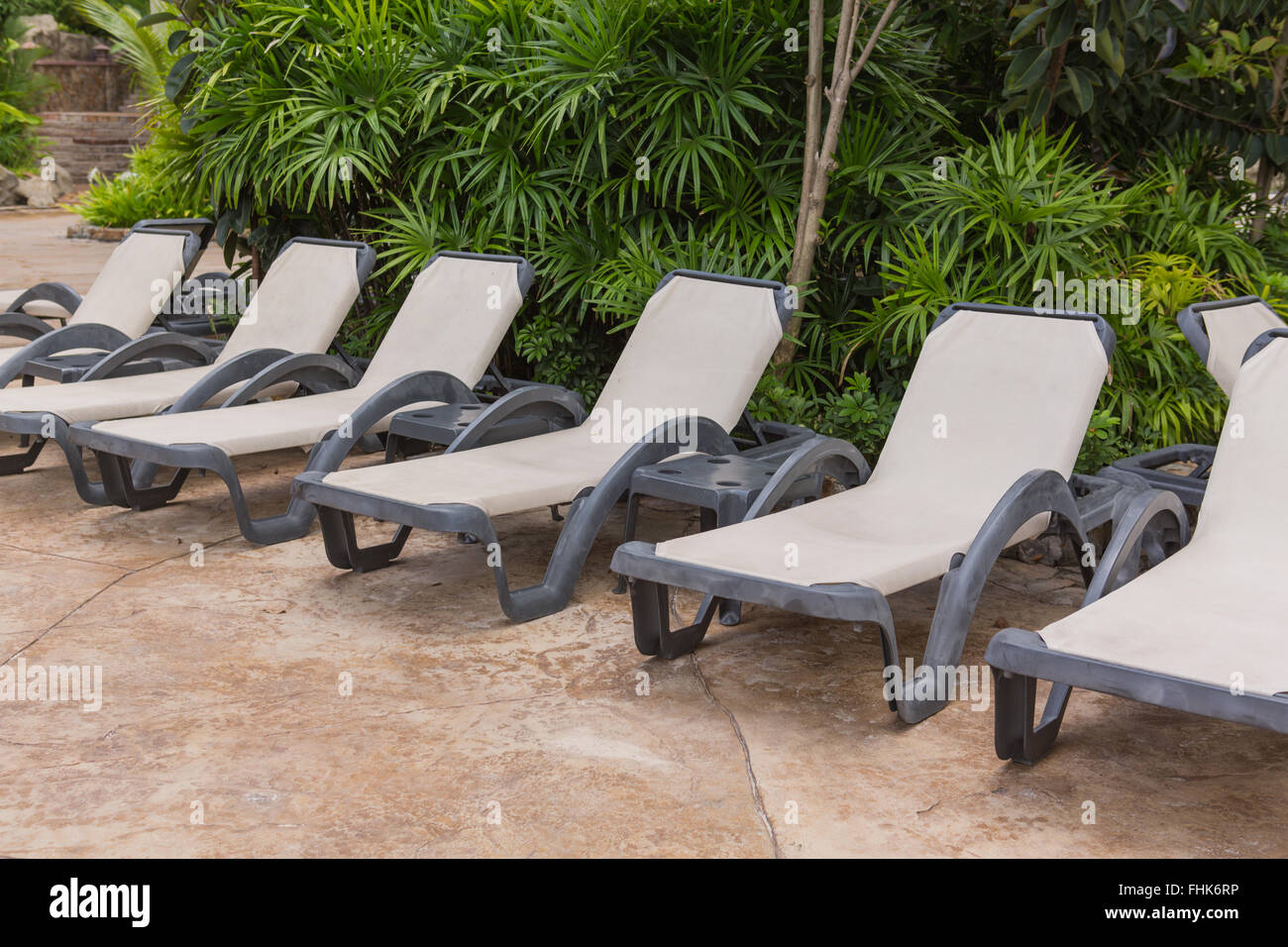 Line of a plastic sunbeds in a luxury hotel Stock Photo - Alamy