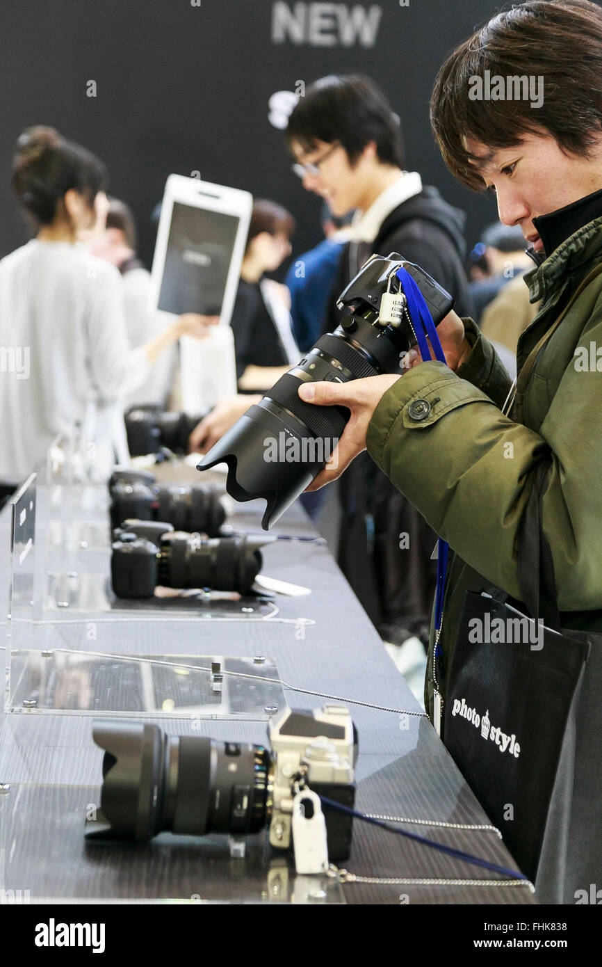 Visitors test Sigma lenses on display at the CP 2016 Camera & Imaging ...