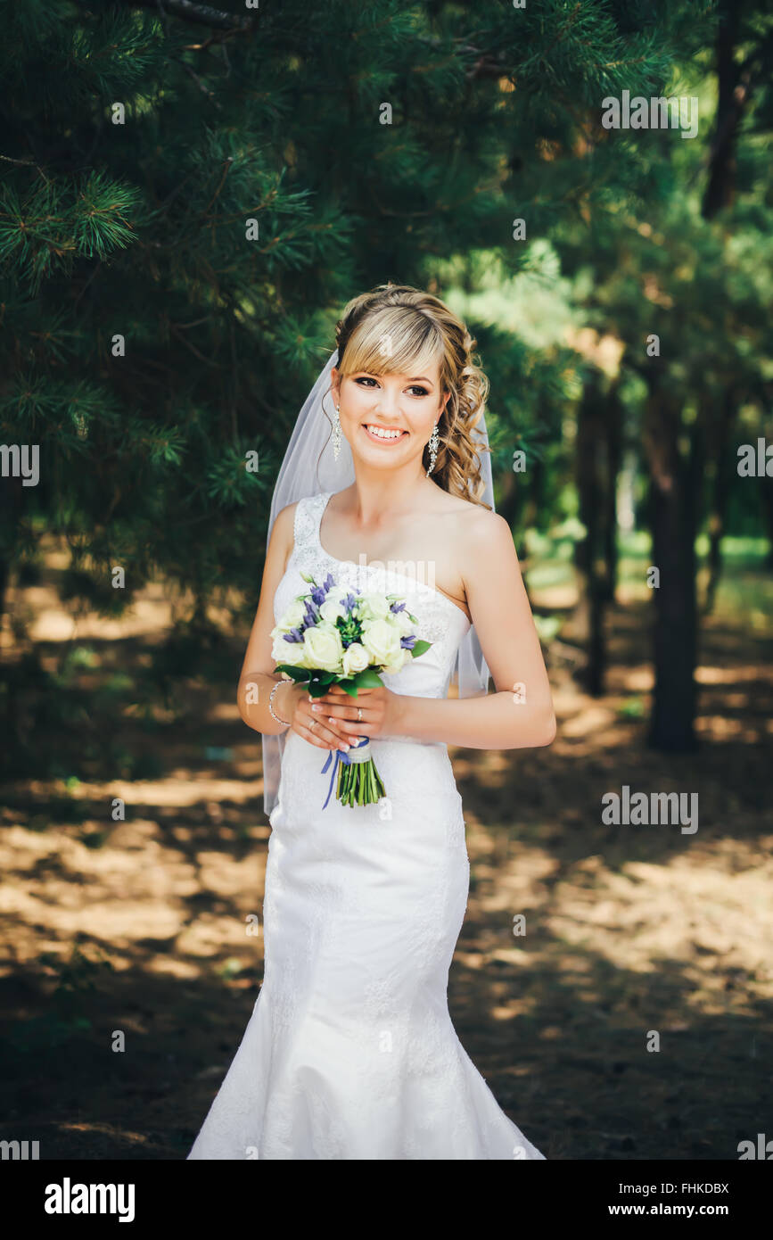 Bride outdoors in a forest Stock Photo - Alamy