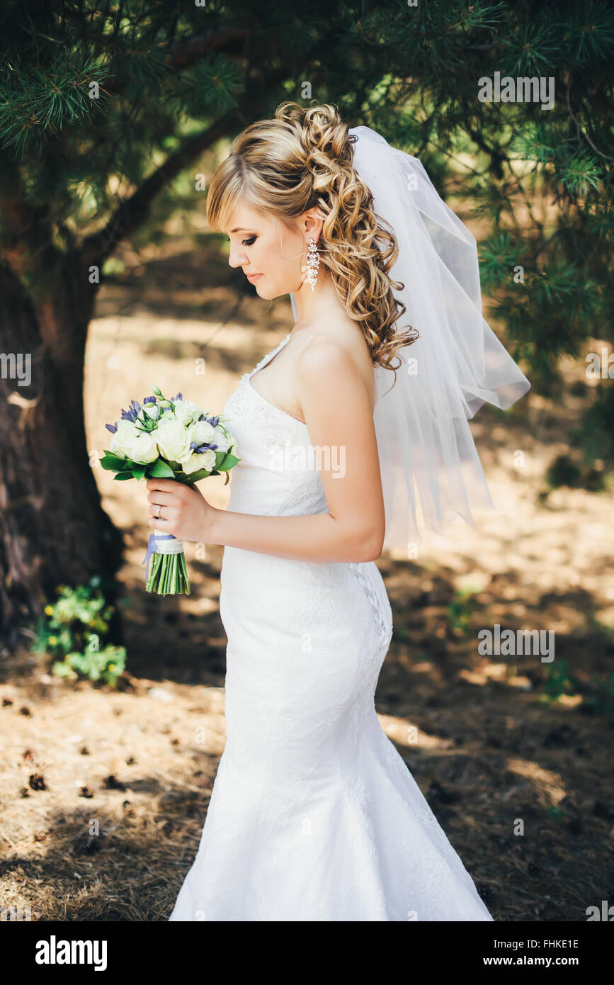 Bride outdoors in a forest Stock Photo - Alamy