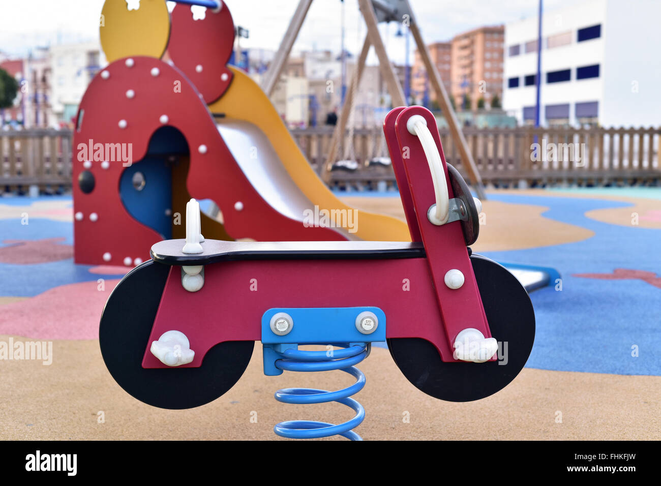 a view of a public urban playground with a spring rider in the ...