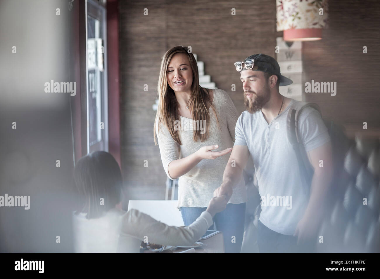 Young woman introducing a friend Stock Photo - Alamy