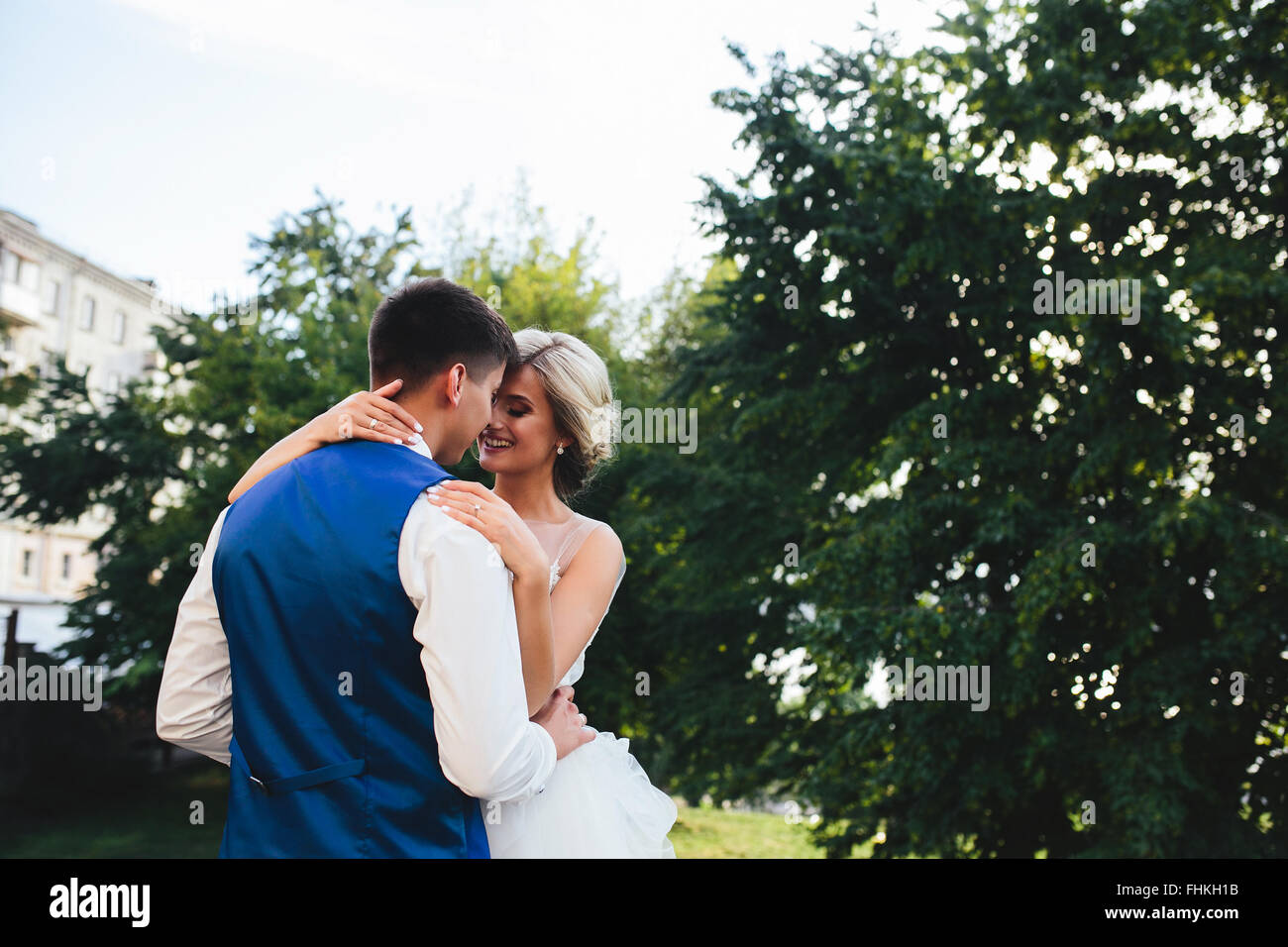 Beautiful wedding couple hugging in the park Stock Photo - Alamy