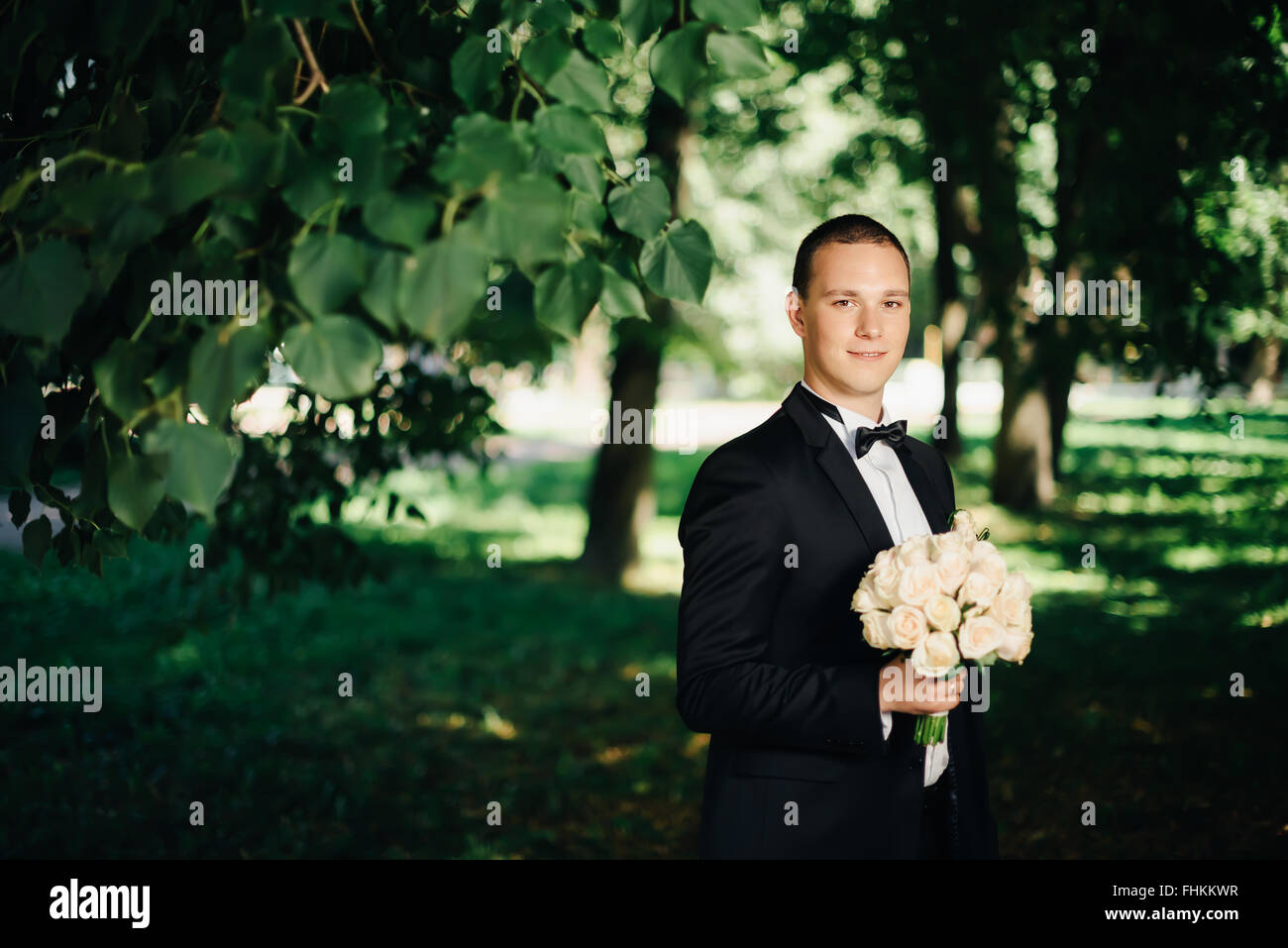 Handsome young groom posing outside in nature Stock Photo - Alamy Handsome young groom posing outside in nature Stock Photo - Alamy