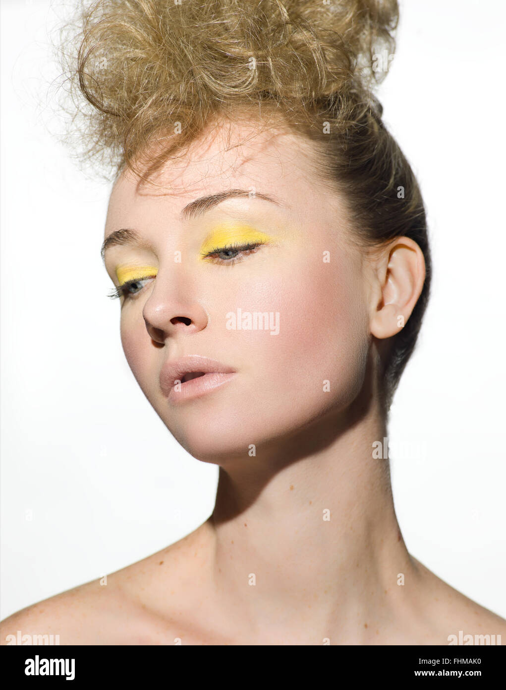 A woman wearing yellow eye shadow Stock Photo - Alamy