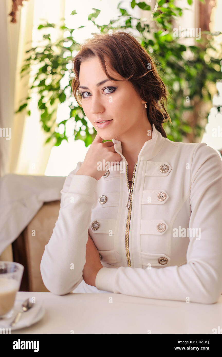 Beautiful girl sitting at table Stock Photo - Alamy