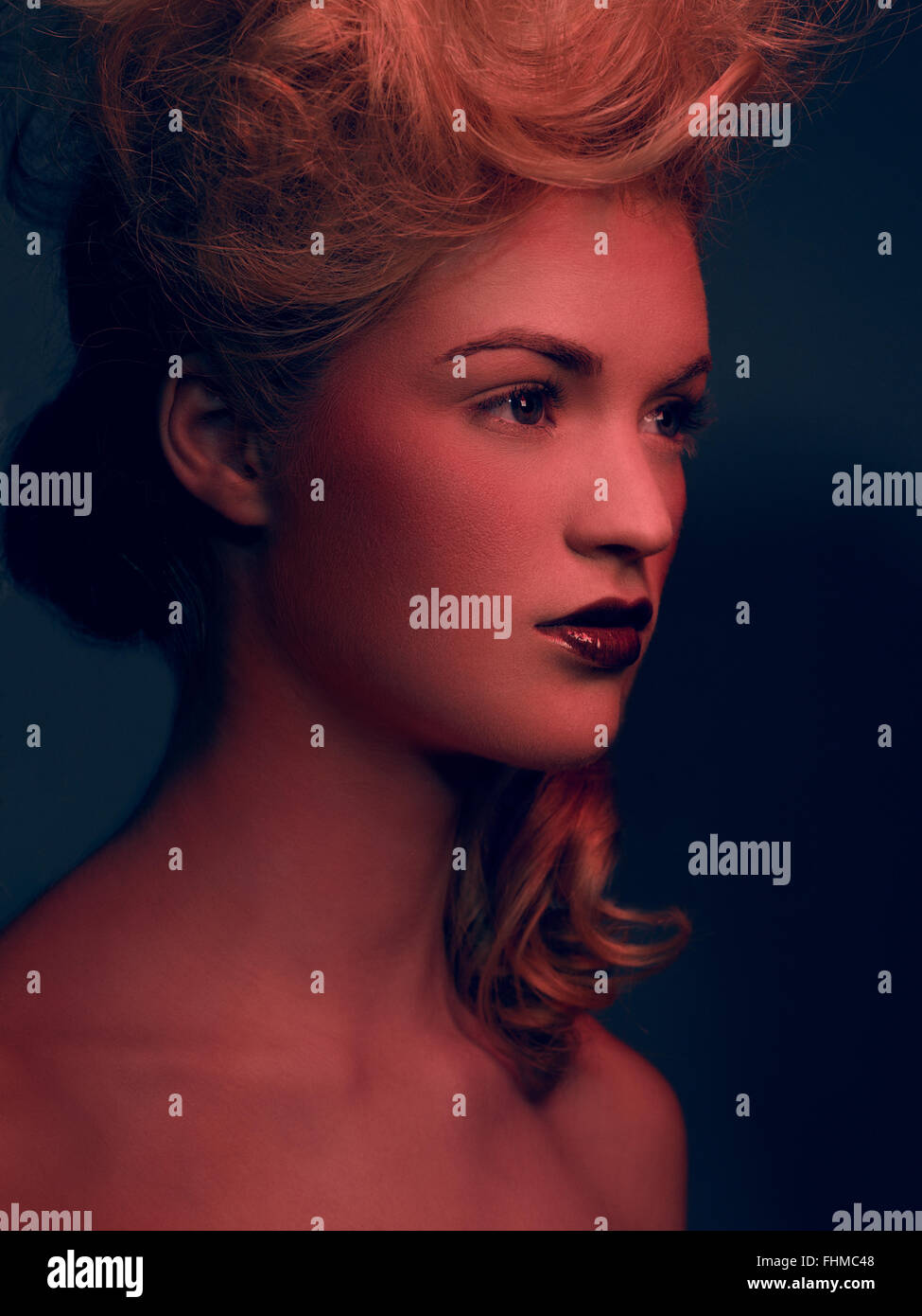 A model in red, moody lighting Stock Photo - Alamy