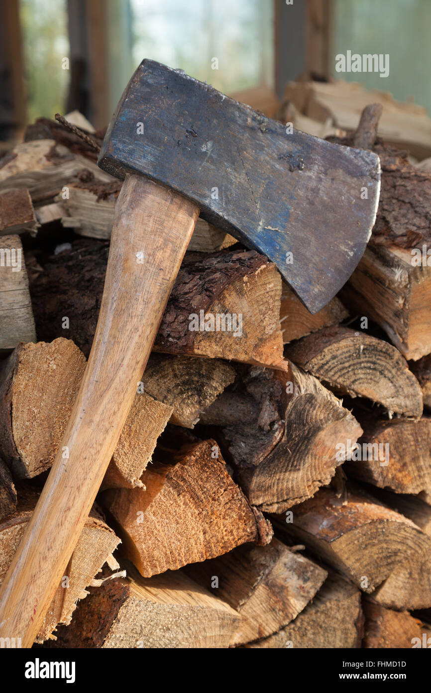 Wooden axe resting on some split firewood Stock Photo - Alamy