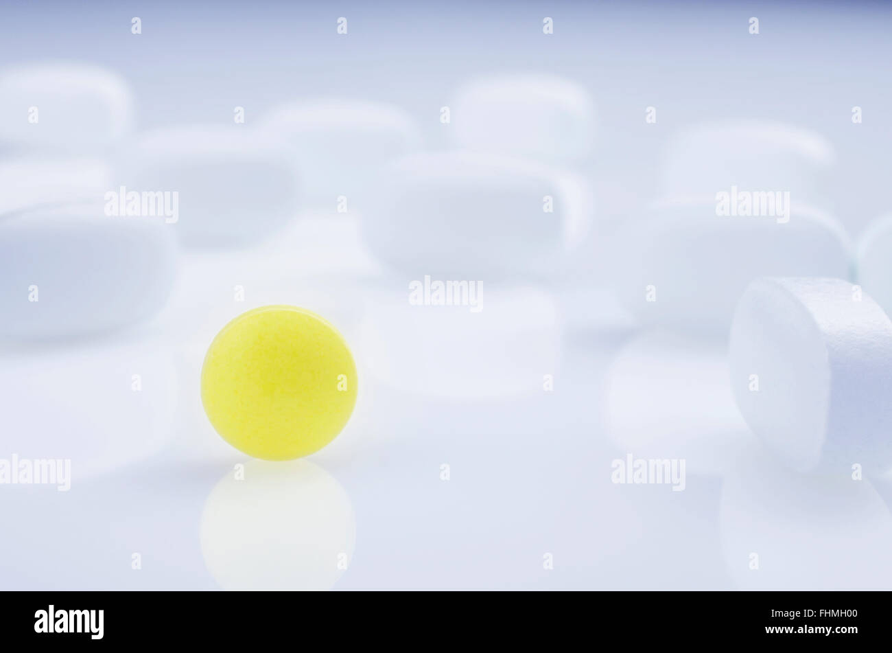 Medicine yellow pill Stock Photo - Alamy