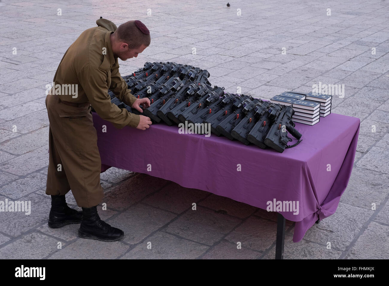 An Israeli religious soldier organizing a table stacked with with TAR ...