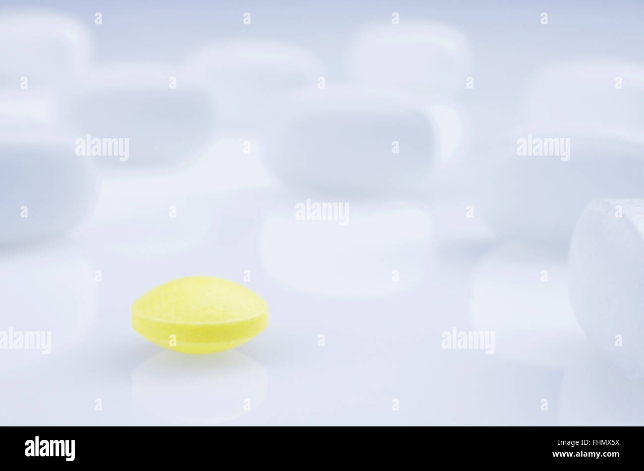 Medicine yellow pill Stock Photo - Alamy