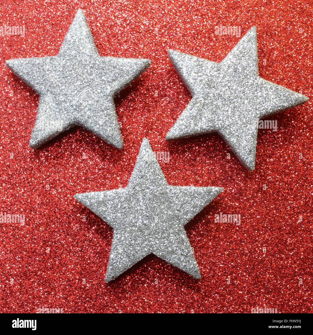 three large silver stars on bright red texture Stock Photo - Alamy