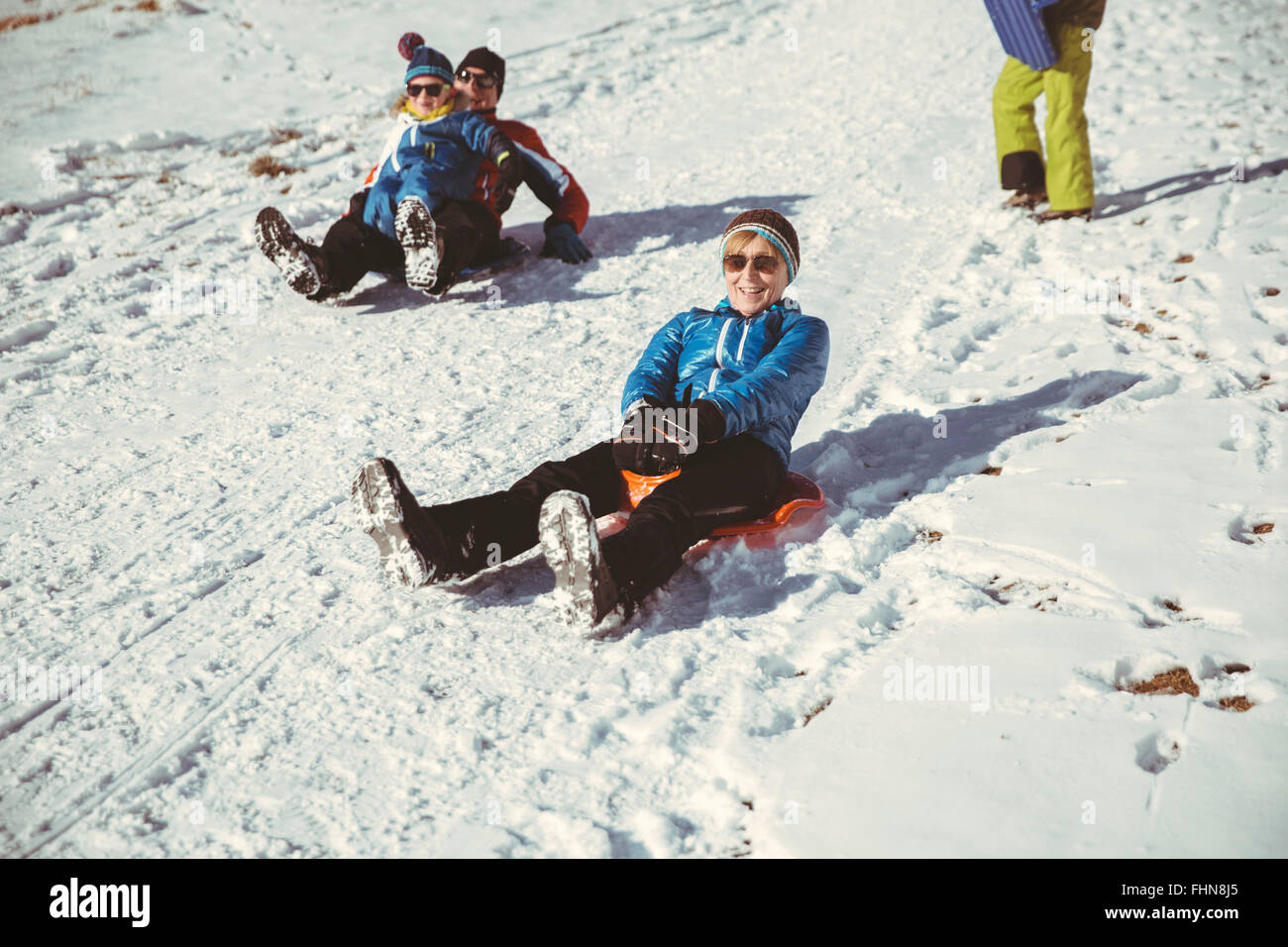 Boy tobogganing down hill hi-res stock photography and images - Alamy