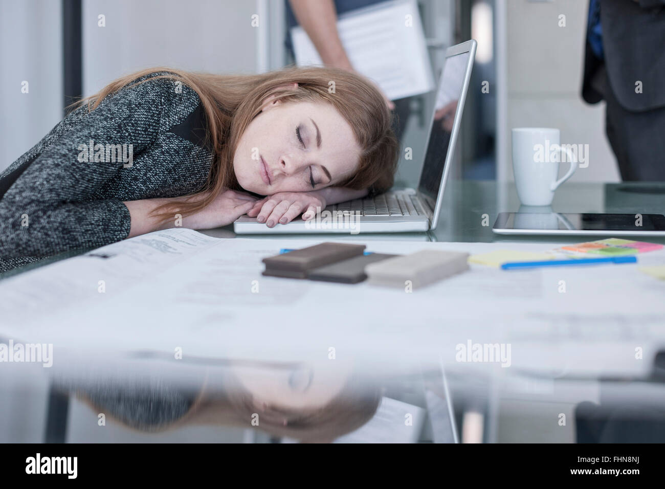 Woman sleeping on table in office Stock Photo - Alamy