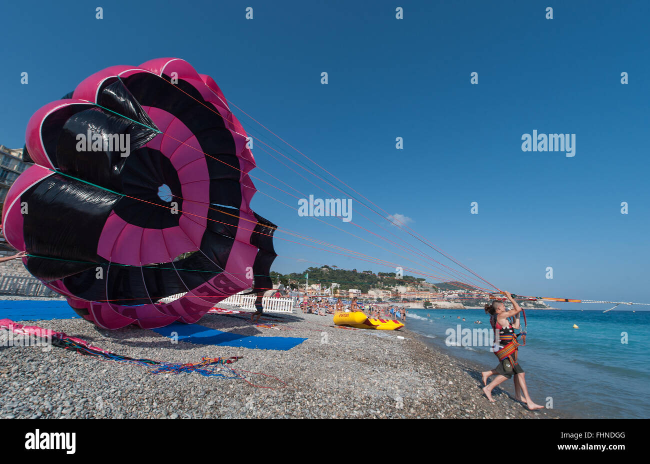 Two people paragliding from the beach at Nice Stock Photo - Alamy