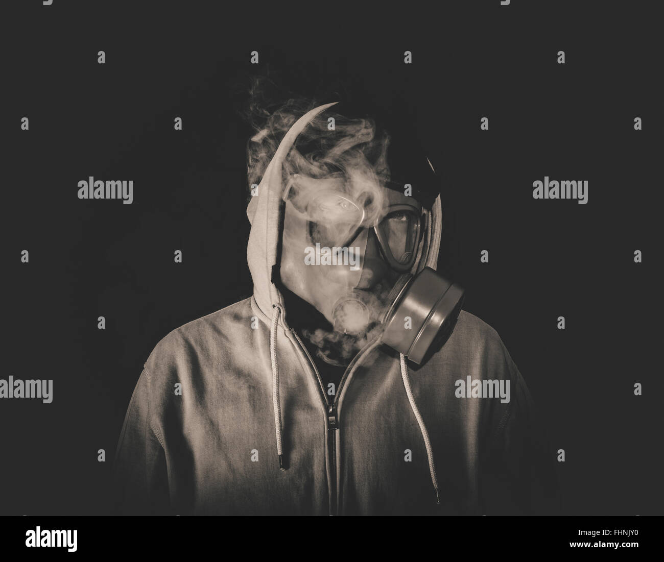 Man wearing mask and smoking,low key and monochrome Stock Photo - Alamy