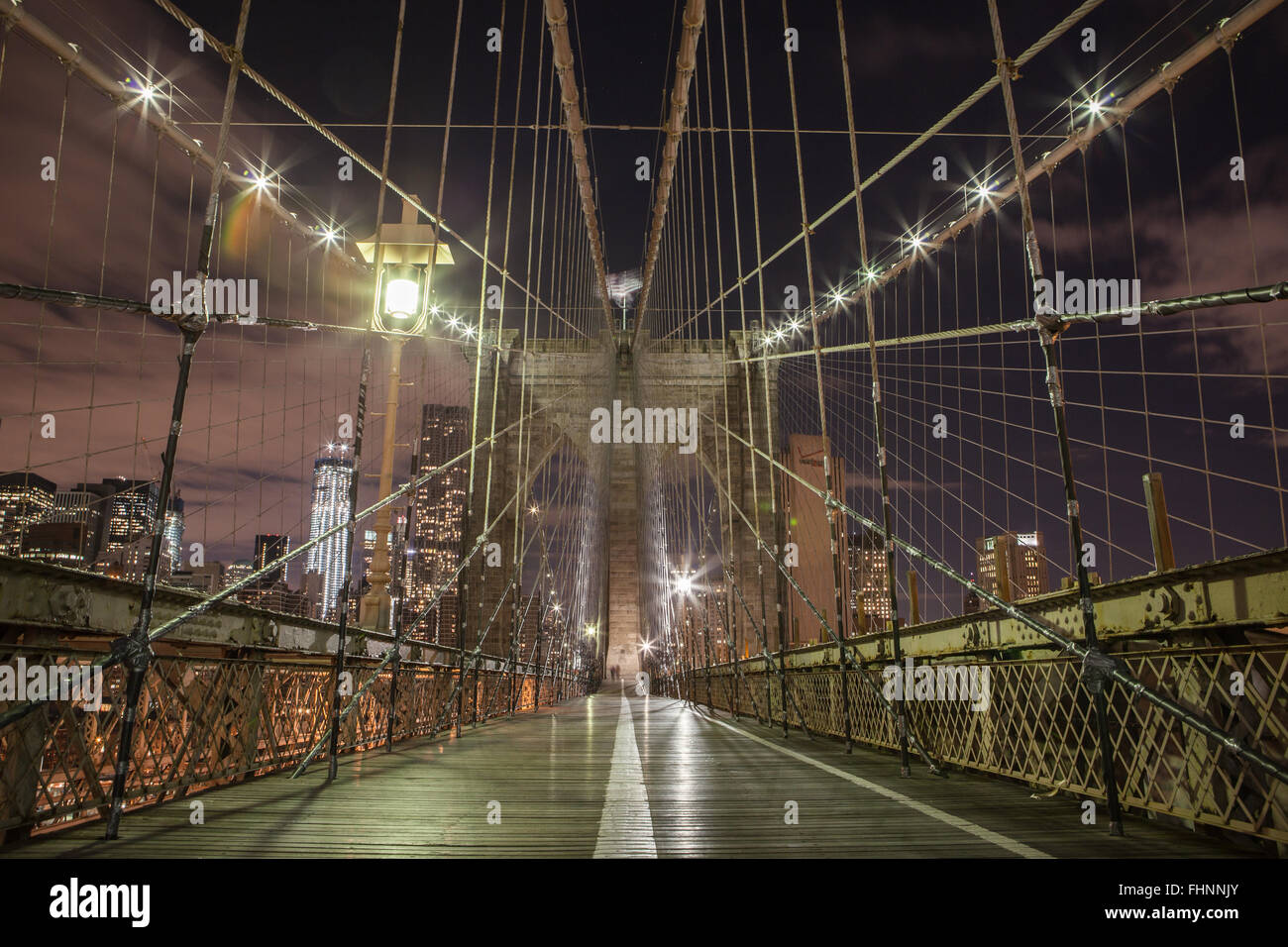 Walking along Brooklyn Bridge at Night Stock Photo - Alamy