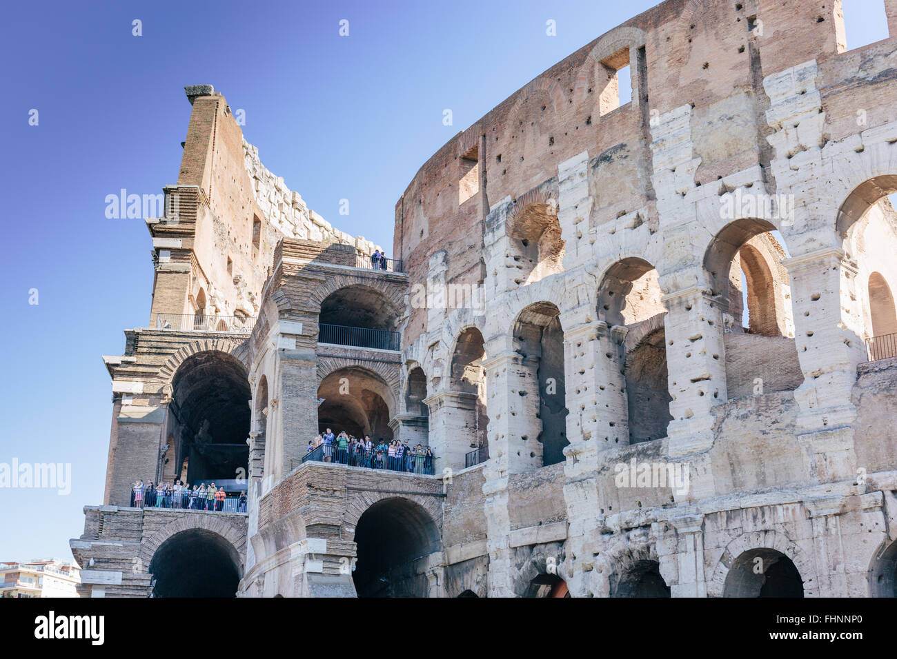 Tourists stand on a viewing platform of the Colosseum in Rome, Italy ...