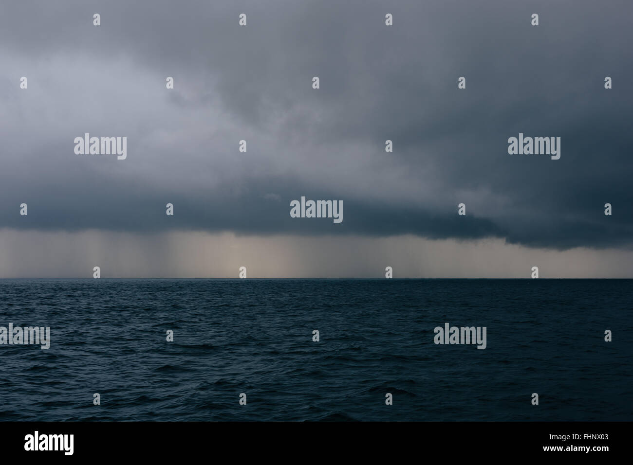 Rain clouds over the ocean, you can see rain showers in the distance ...