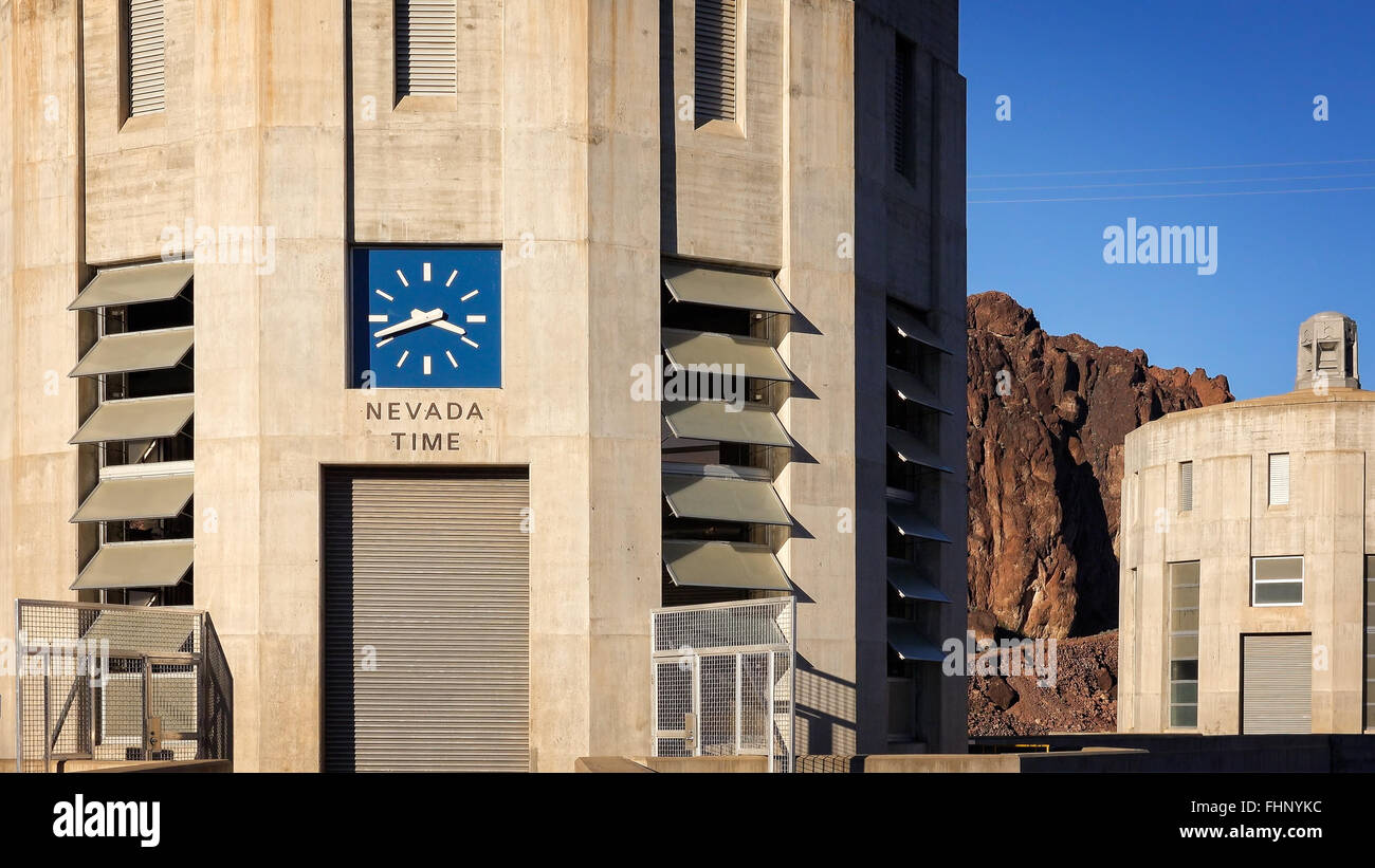 A clock showing Nevada time on the Nevada side of the Hoover Dam Stock ...