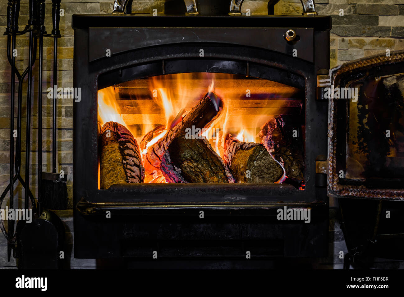 Old fireplace with a burning firewoods Stock Photo - Alamy