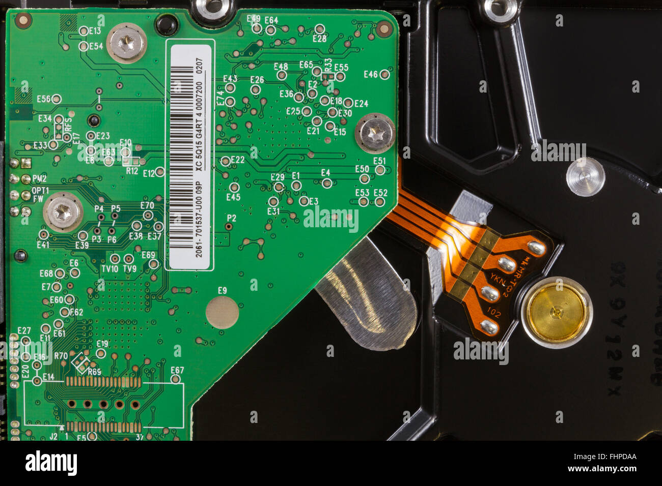 Close-up inside a hard disk showing the printed circuit board and the ...