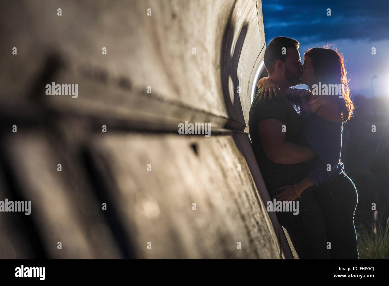 Couple in love kissing at a wall Stock Photo - Alamy