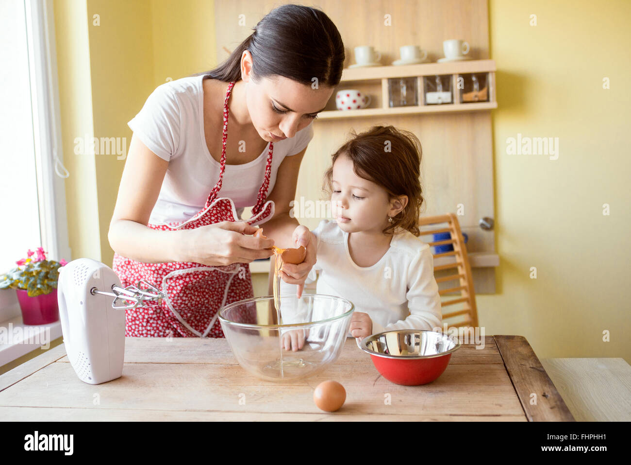 Mother and her little daughter baking together Stock Photo - Alamy