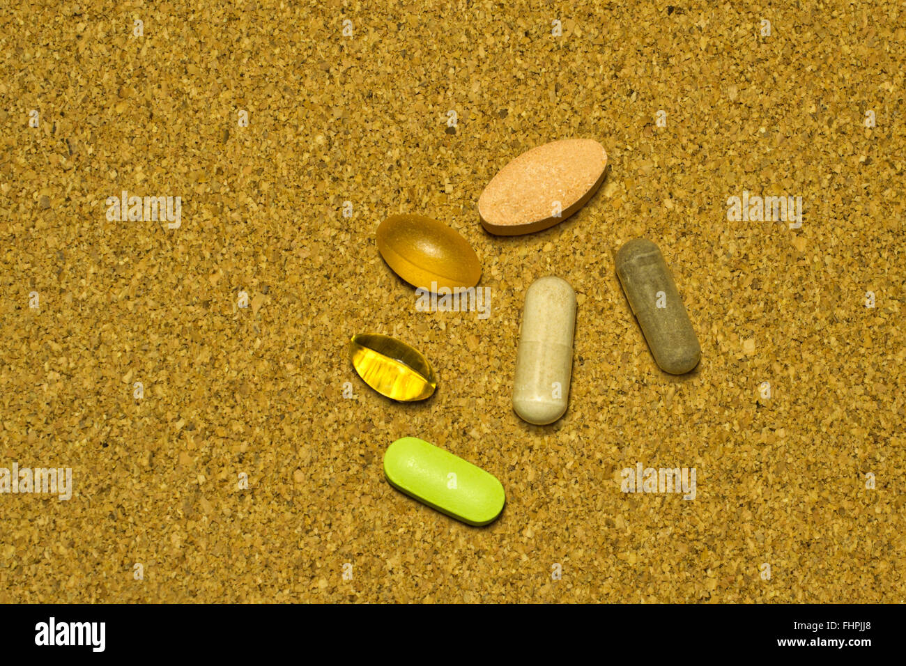 An assortment of dietary supplements on cork background Stock Photo - Alamy
