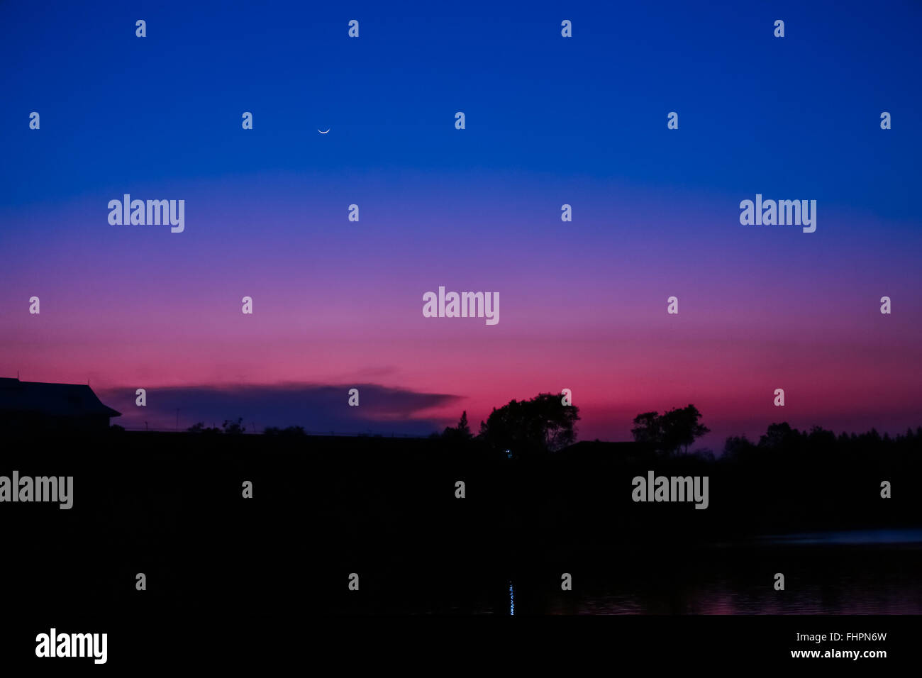 Purple sunset in Thailand and a moon on the sky Stock Photo - Alamy