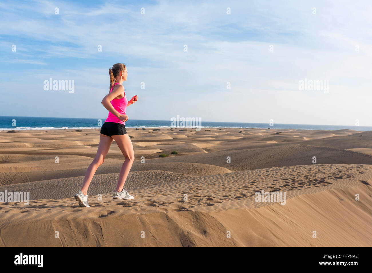 Young woman jogging on the beach Stock Photo - Alamy