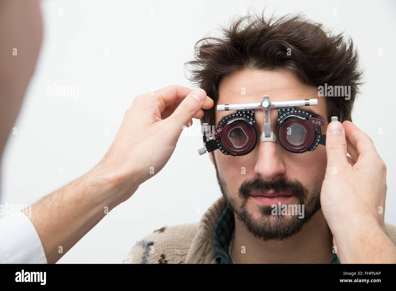 Man at the optometrist making an eye test Stock Photo - Alamy