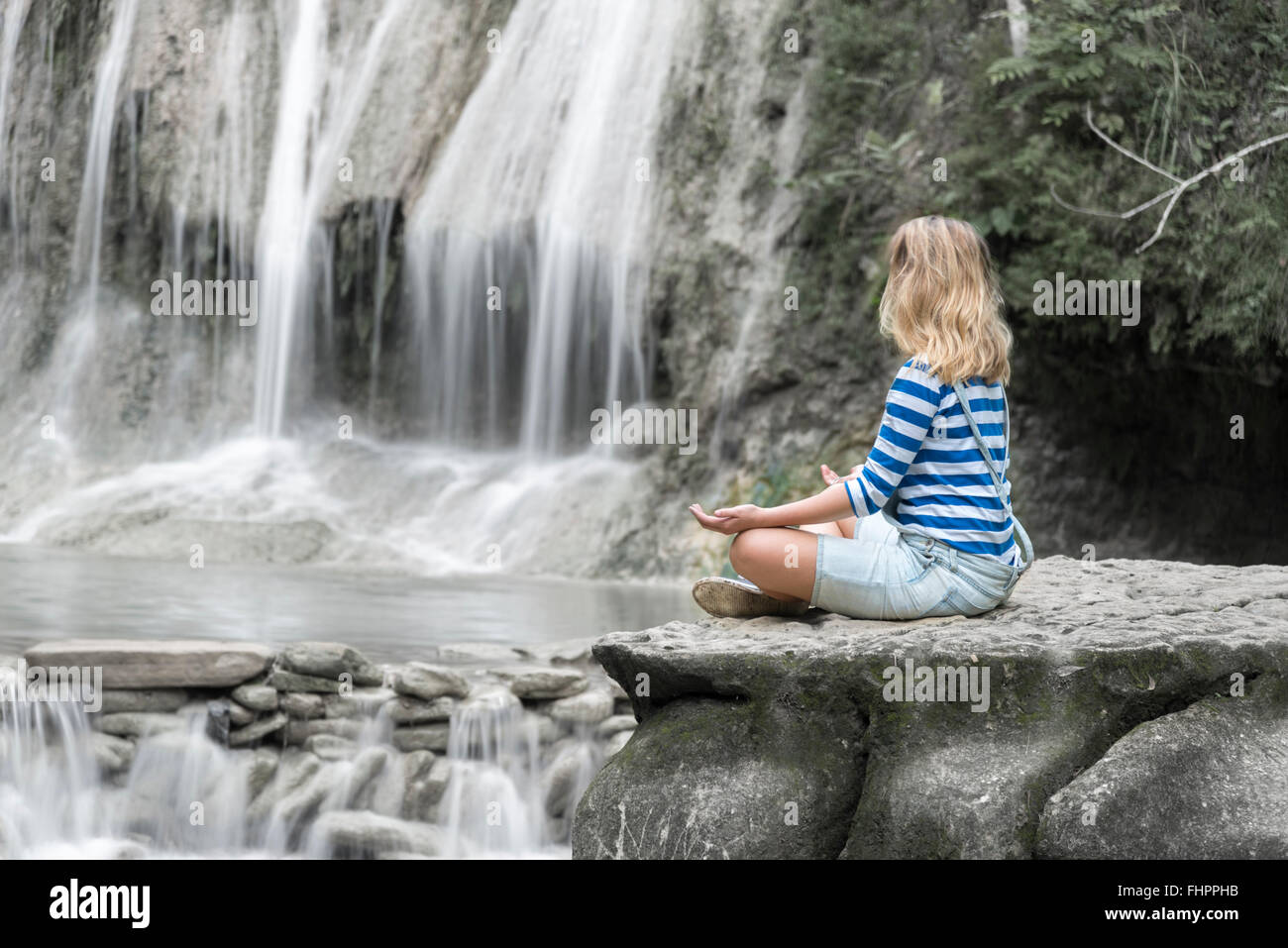 Young girl sitting waterfall hi-res stock photography and images - Alamy