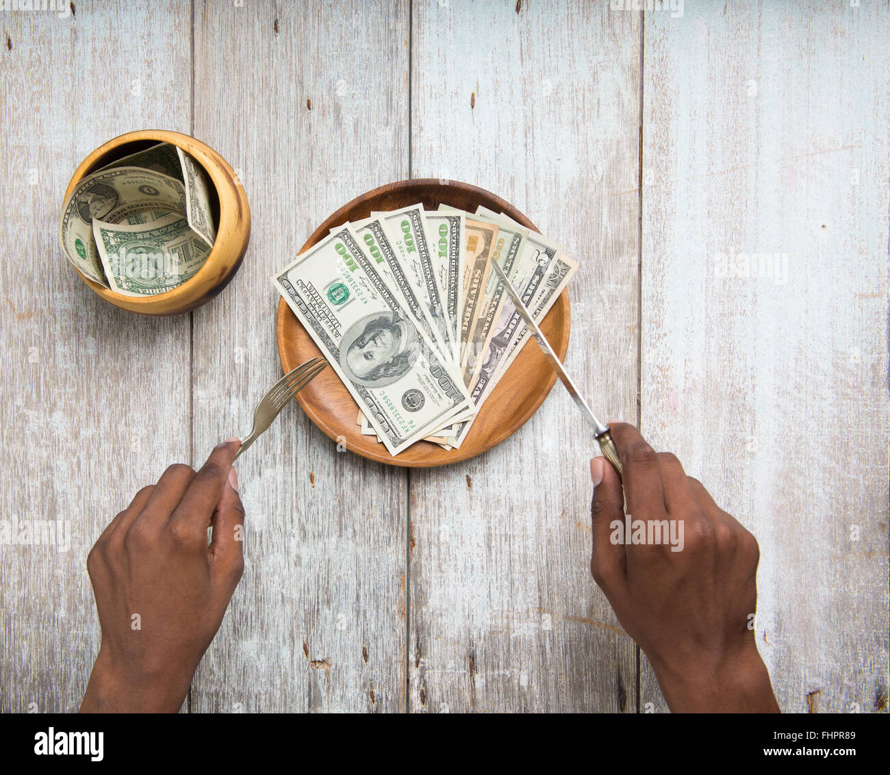 hand eating banknotes symbolising consumerism and corruption Stock ...