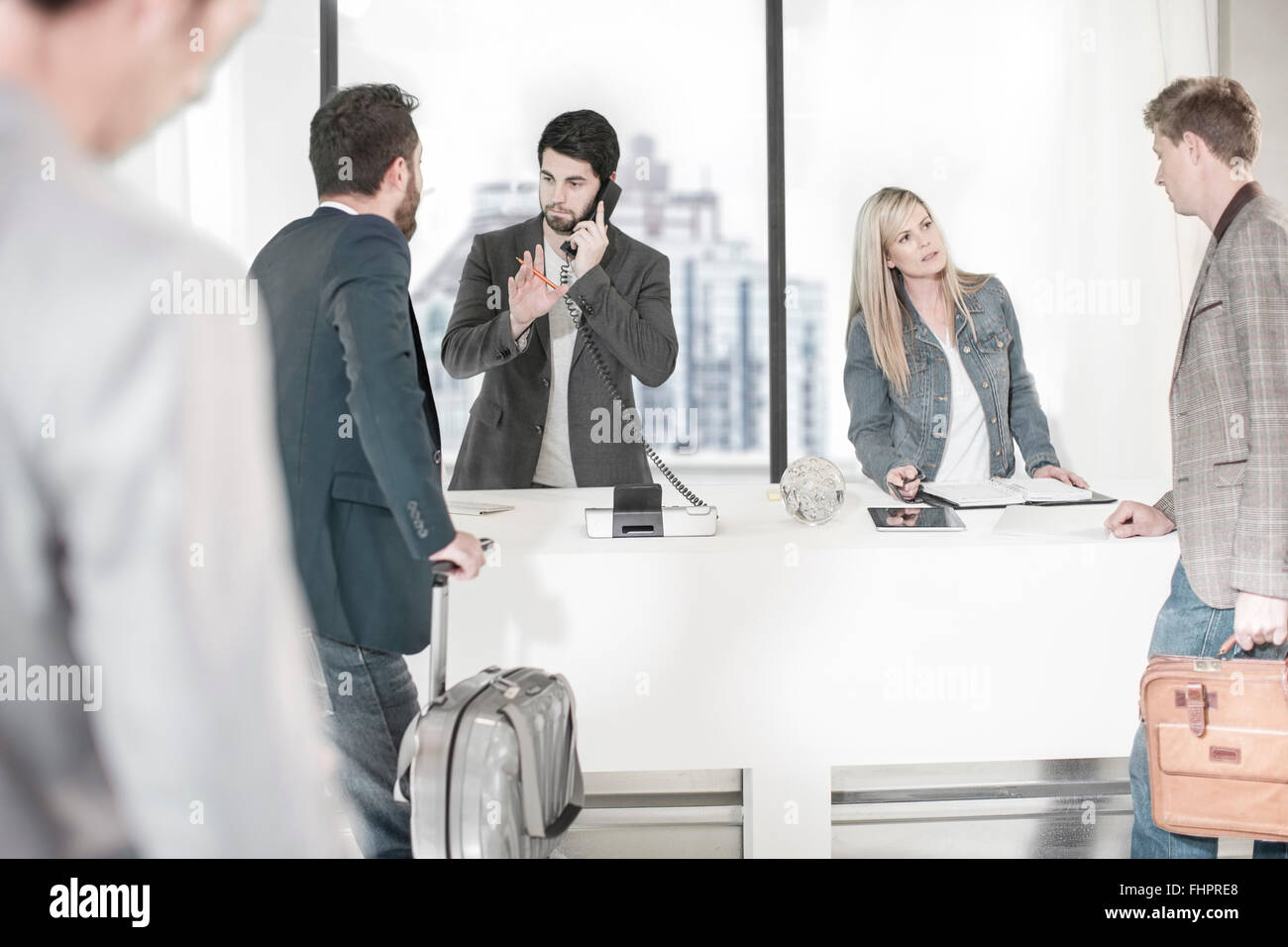 Businessmen arriving at office reception Stock Photo - Alamy