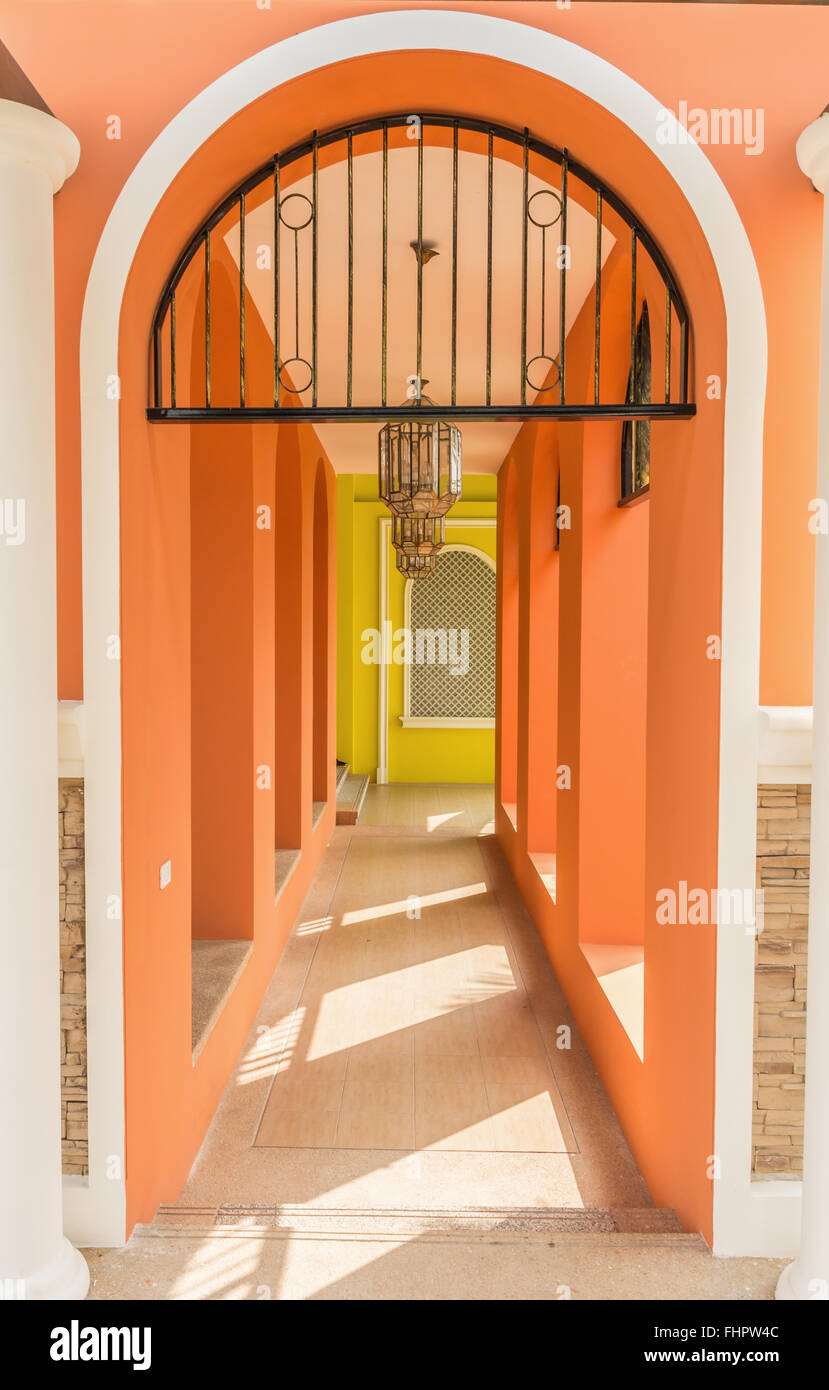 Building with orange arches and vintage lamps hanging Stock Photo - Alamy