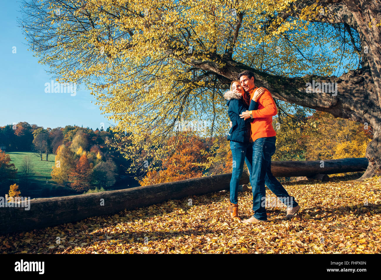 Happy couple embracing in autumn forest Stock Photo - Alamy