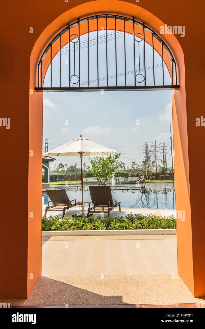 orange arches with Beach chairs side swimming pool at Thailand Stock ...
