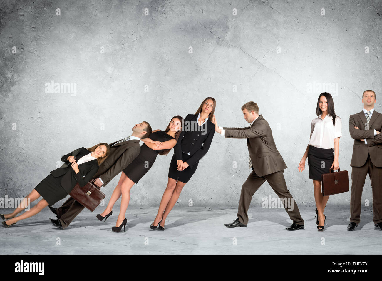 Businessman supporting business people Stock Photo - Alamy