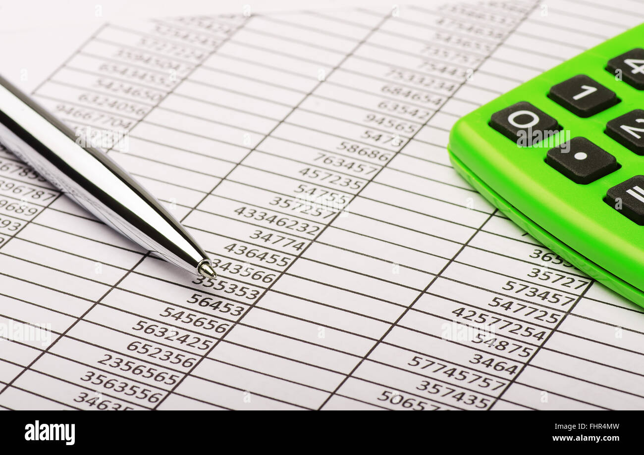 Calculator and pen on financial report Stock Photo - Alamy