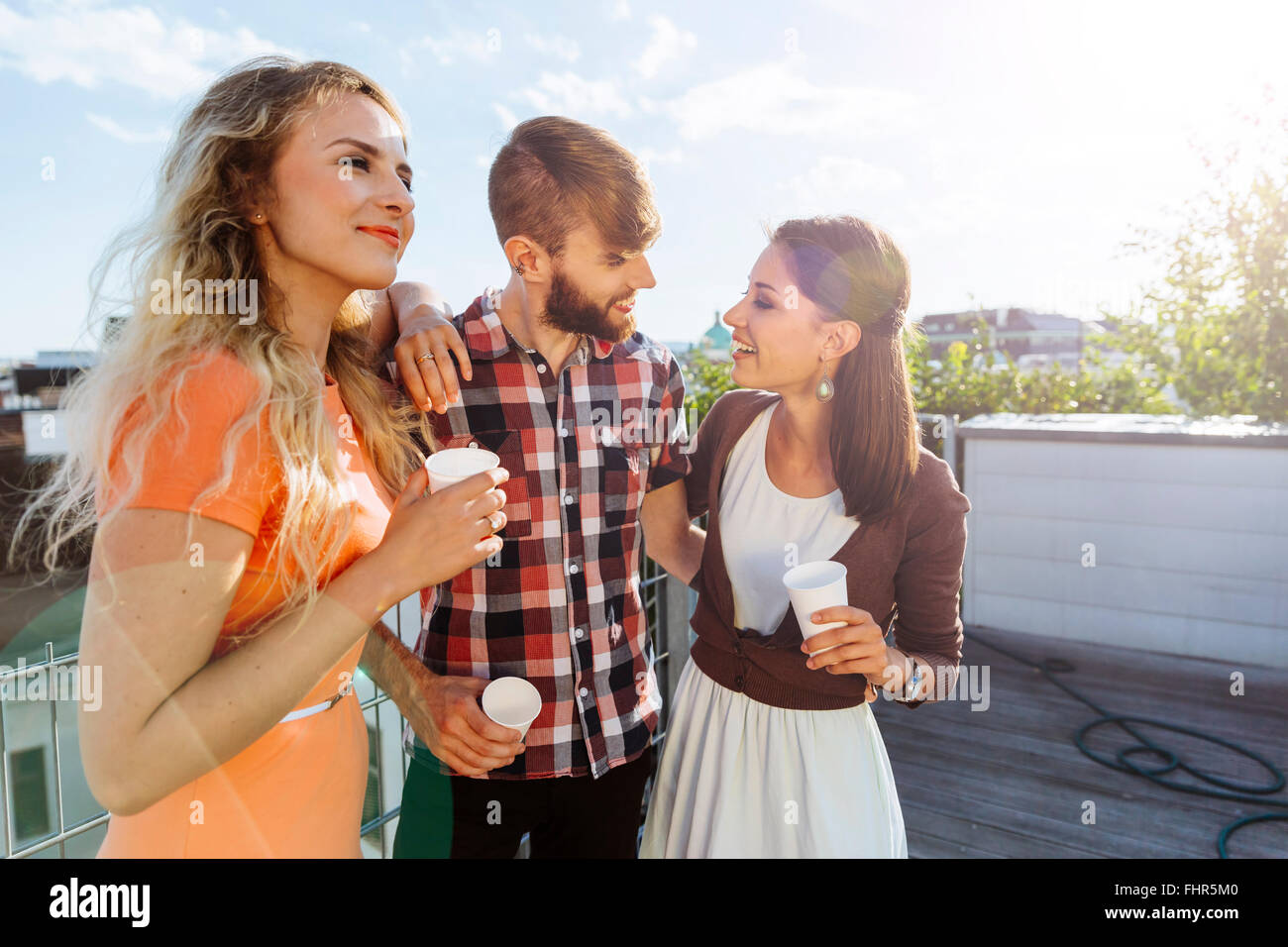 Austria, Vienna, Young people having a party on rooftop terrace Stock ...