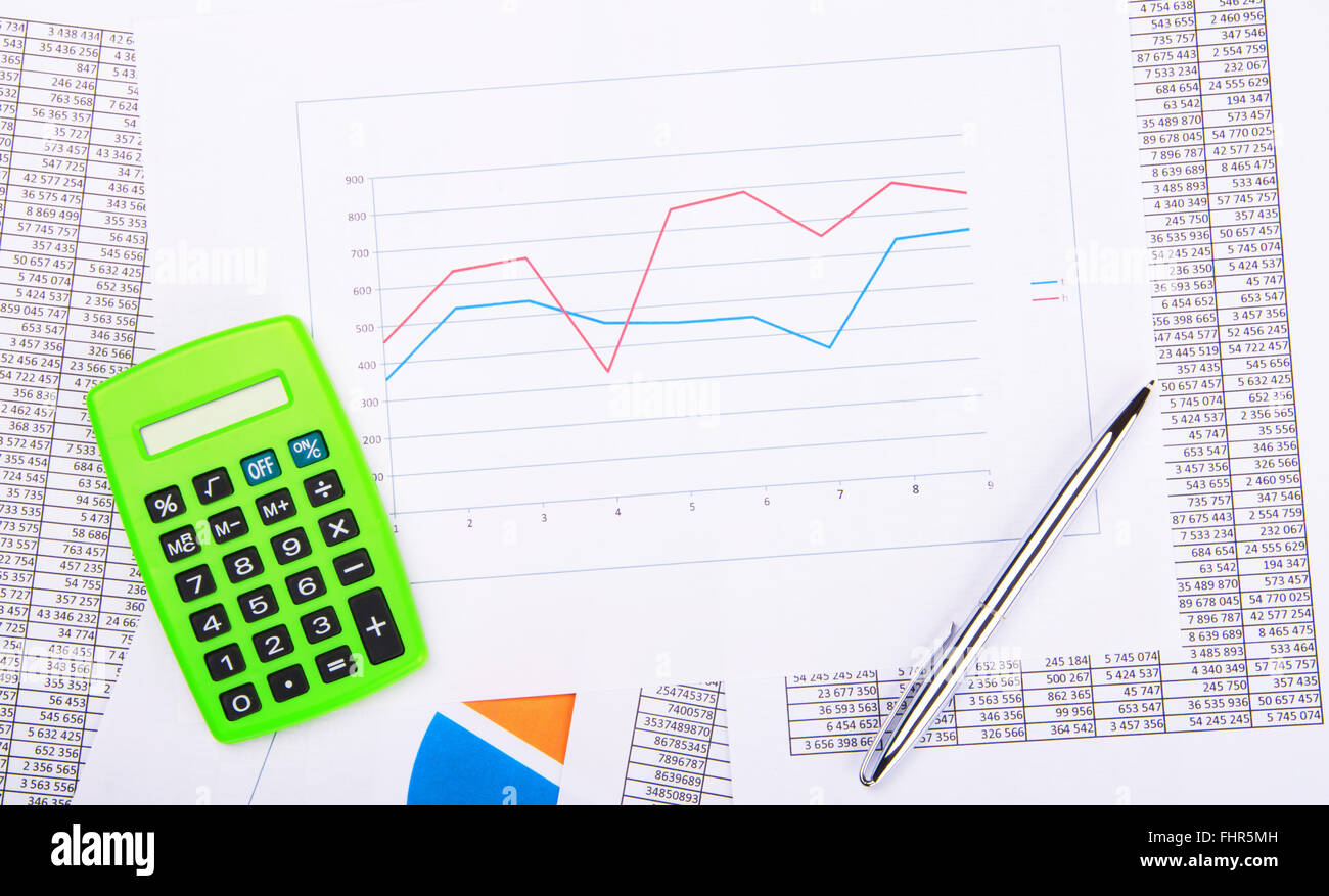 Calculator and pen on financial report with diagram Stock Photo - Alamy