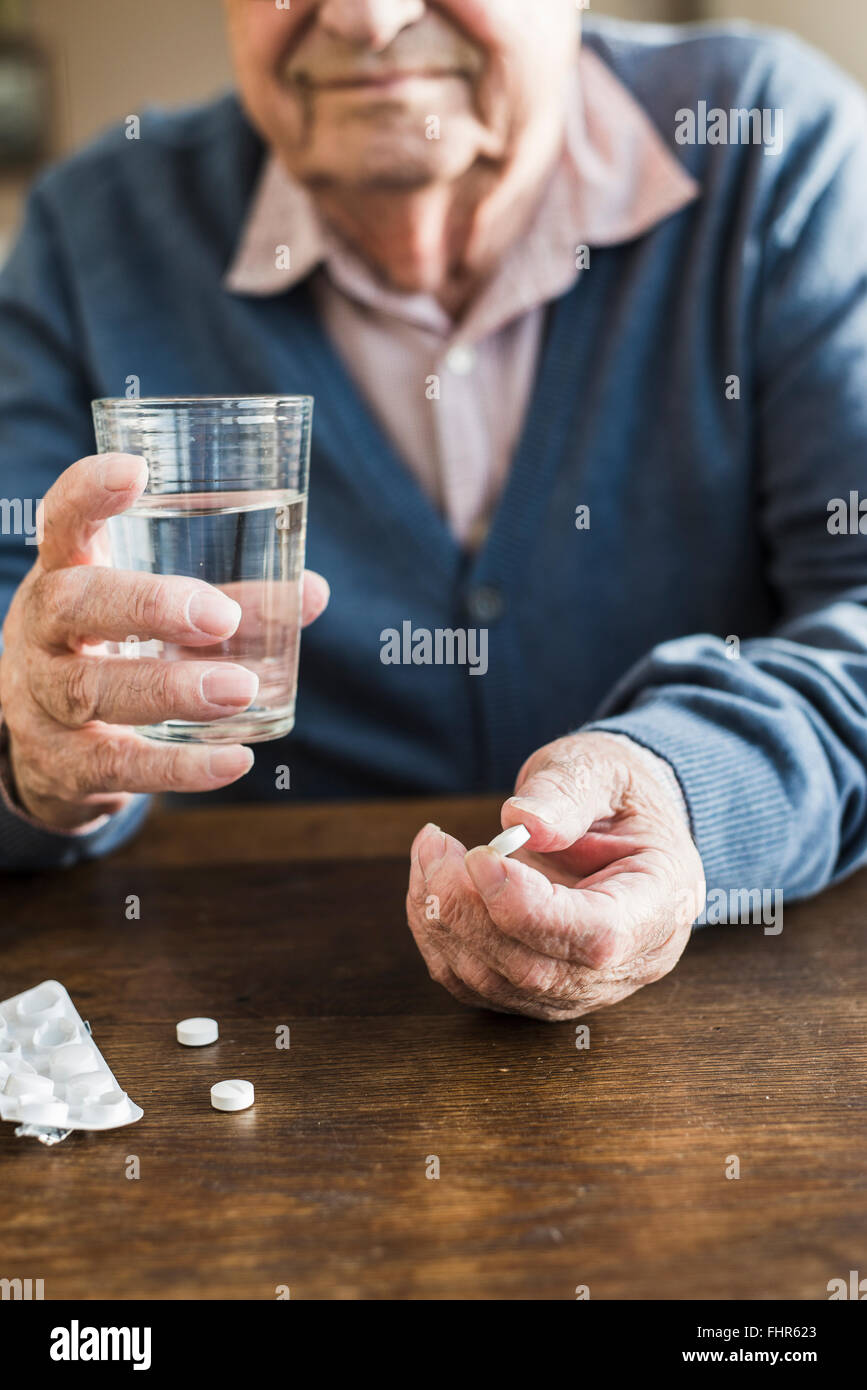 Senior man taking medicine, close-up Stock Photo - Alamy
